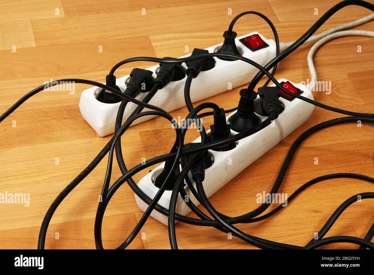Overloaded power boards, close up Stock Photo - Alamy