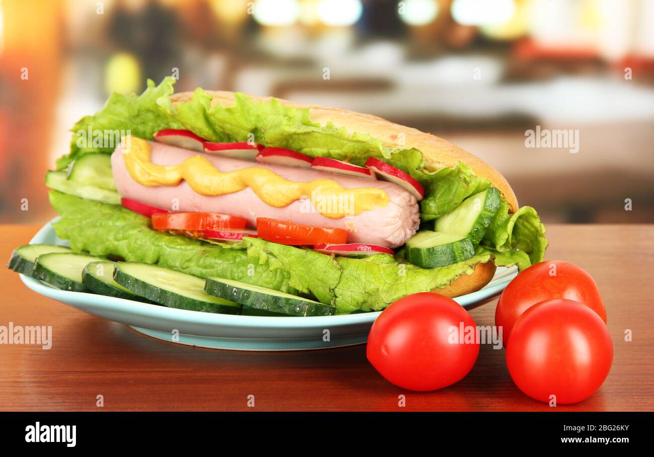Tasty hot dog on table in cafe Stock Photo - Alamy