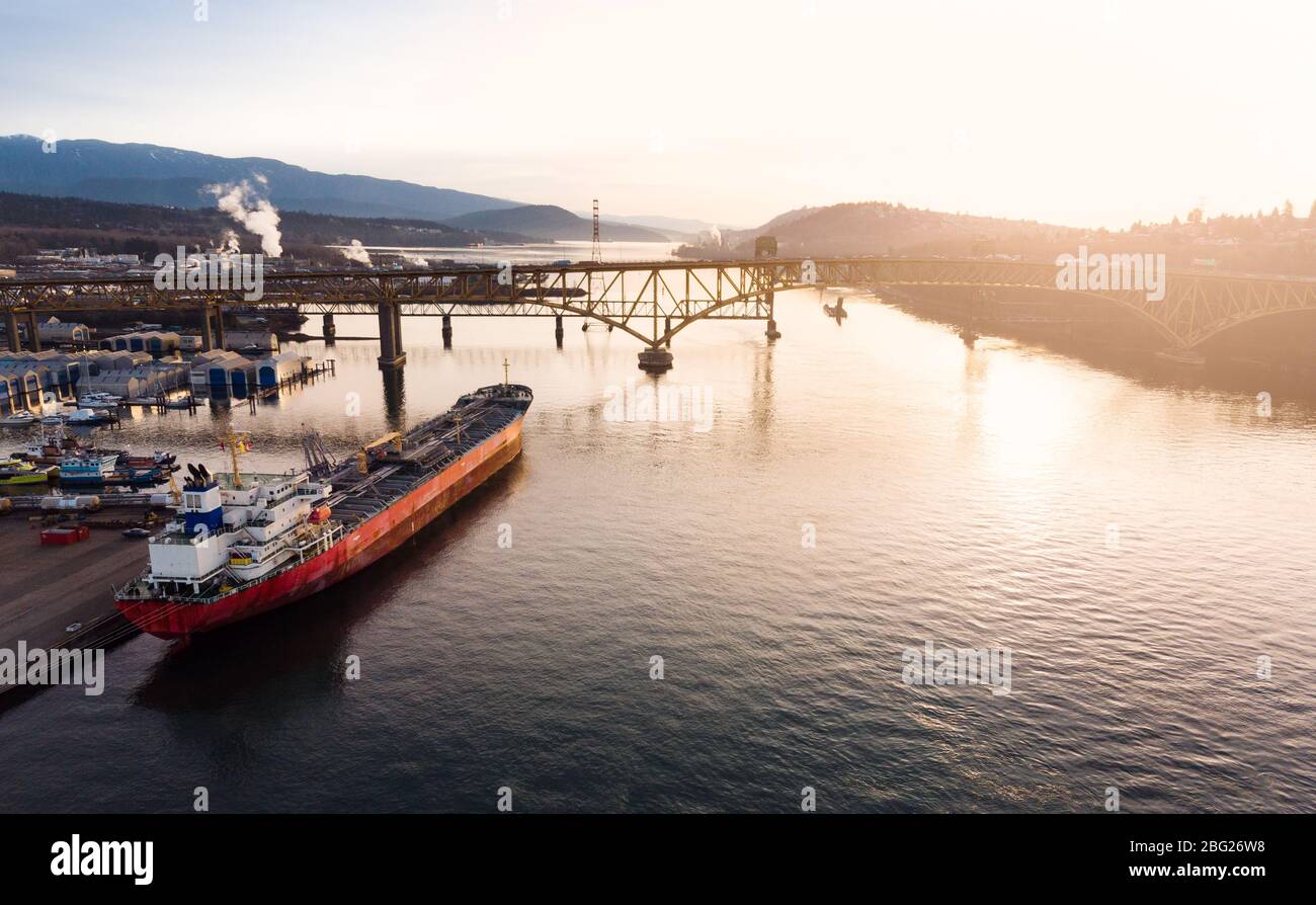 Aerial drone shot of a industrial shipyard and cargo ship loading port ...