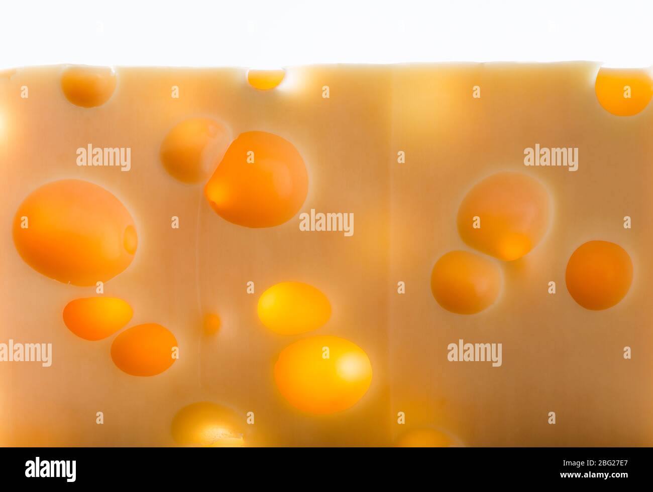 Close-up of a piece of emmental cheese Stock Photo - Alamy