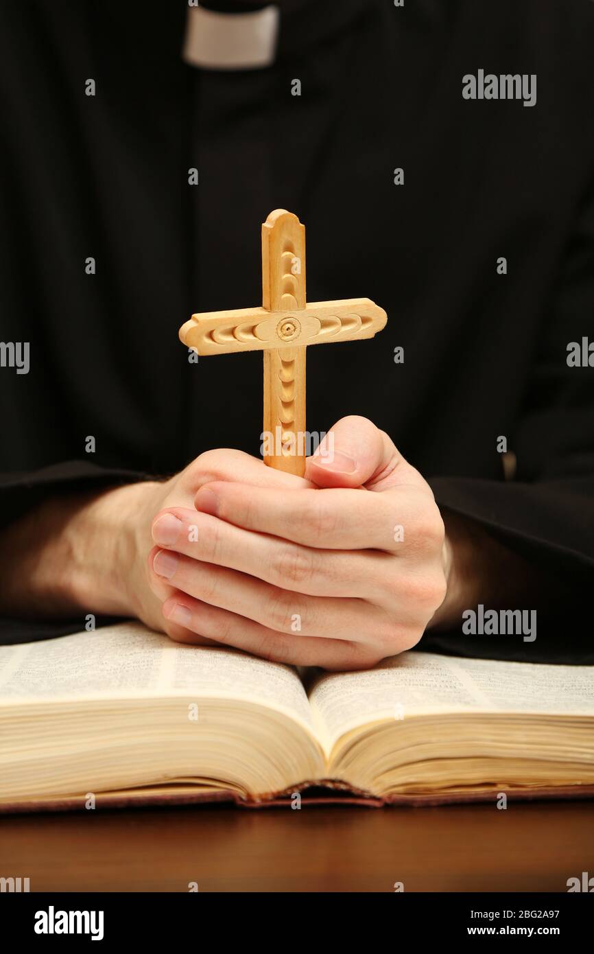 Priest reading from the holy bible, close up Stock Photo - Alamy