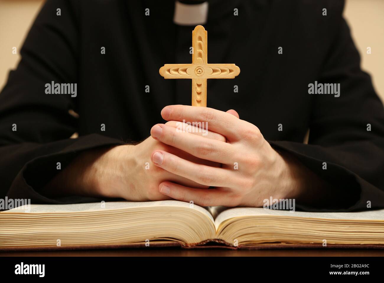 Priest reading from the holy bible, close up Stock Photo - Alamy