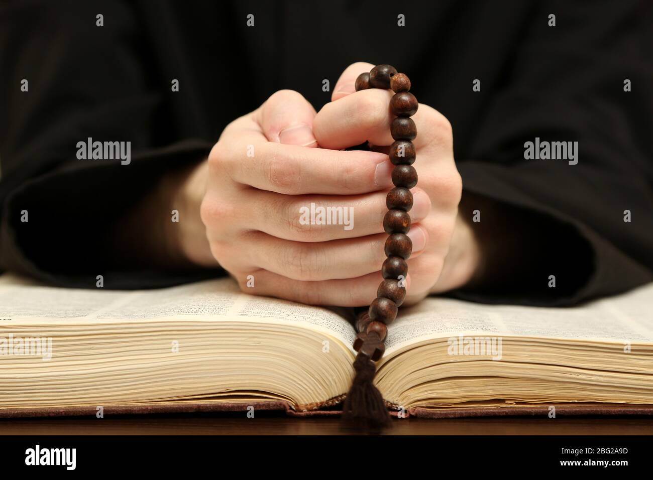 Priest reading from the holy bible, close up Stock Photo - Alamy