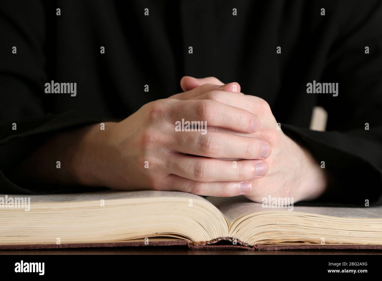 Priest reading from the holy bible, close up Stock Photo - Alamy