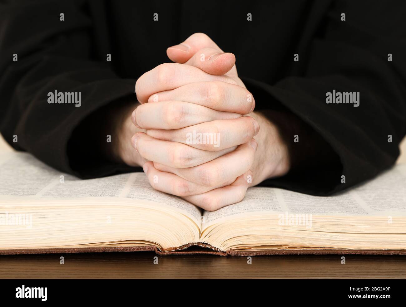 Priest reading from the holy bible, close up Stock Photo - Alamy
