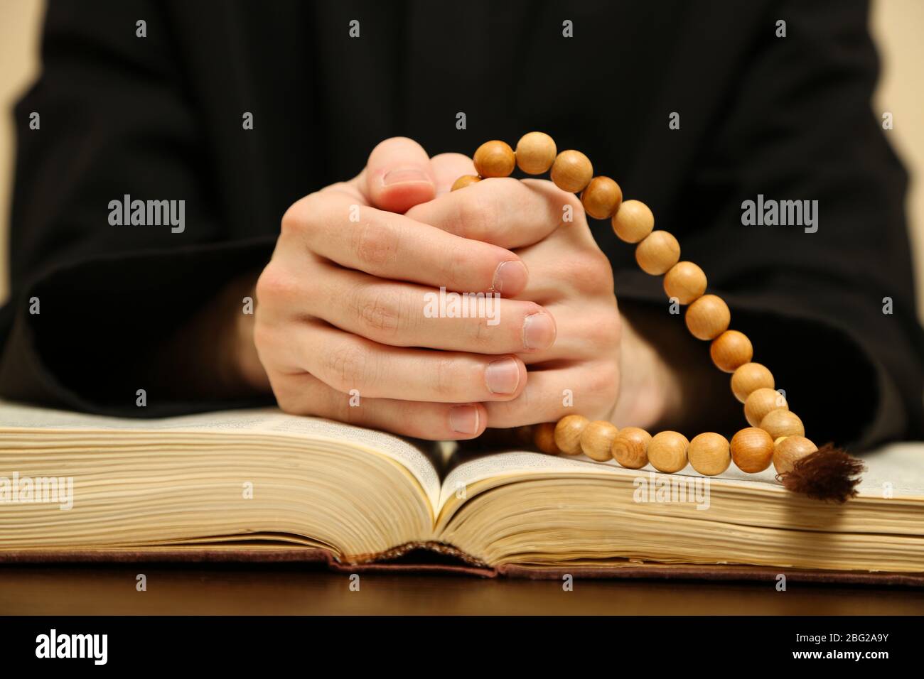 Priest reading from the holy bible, close up Stock Photo - Alamy