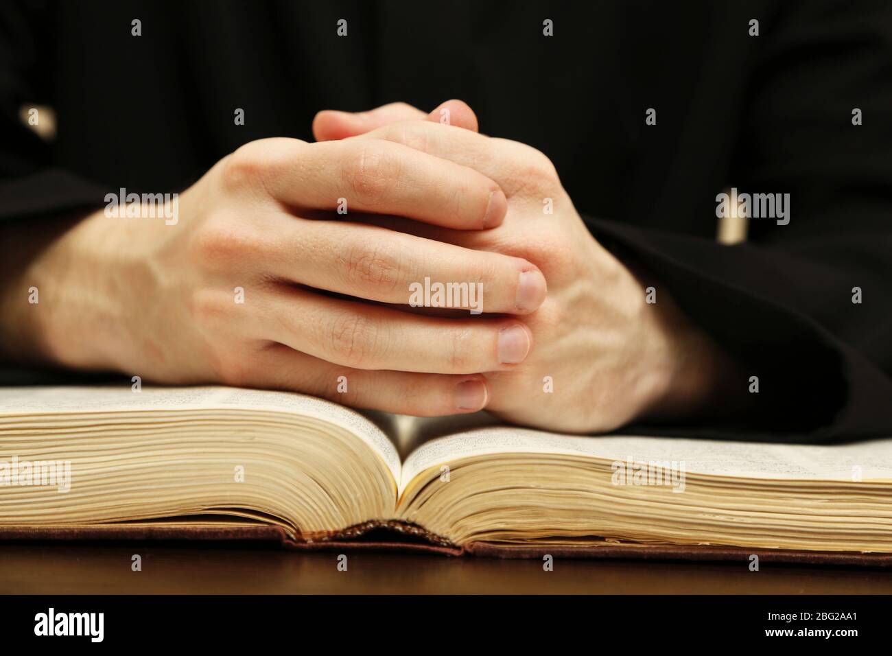 Priest reading from the holy bible, close up Stock Photo - Alamy