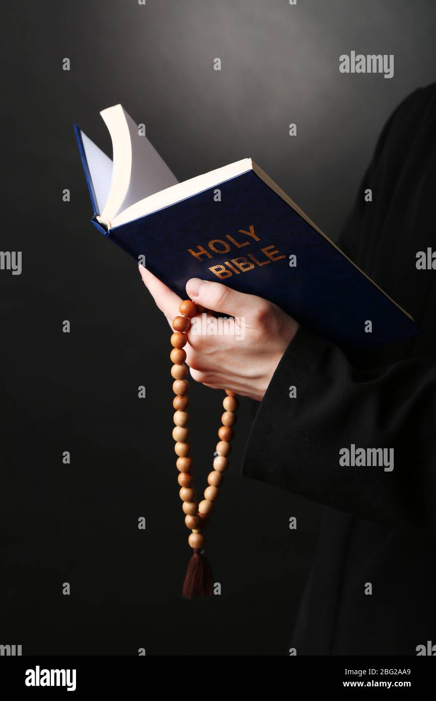 Priest reading from the holy bible, close up Stock Photo - Alamy