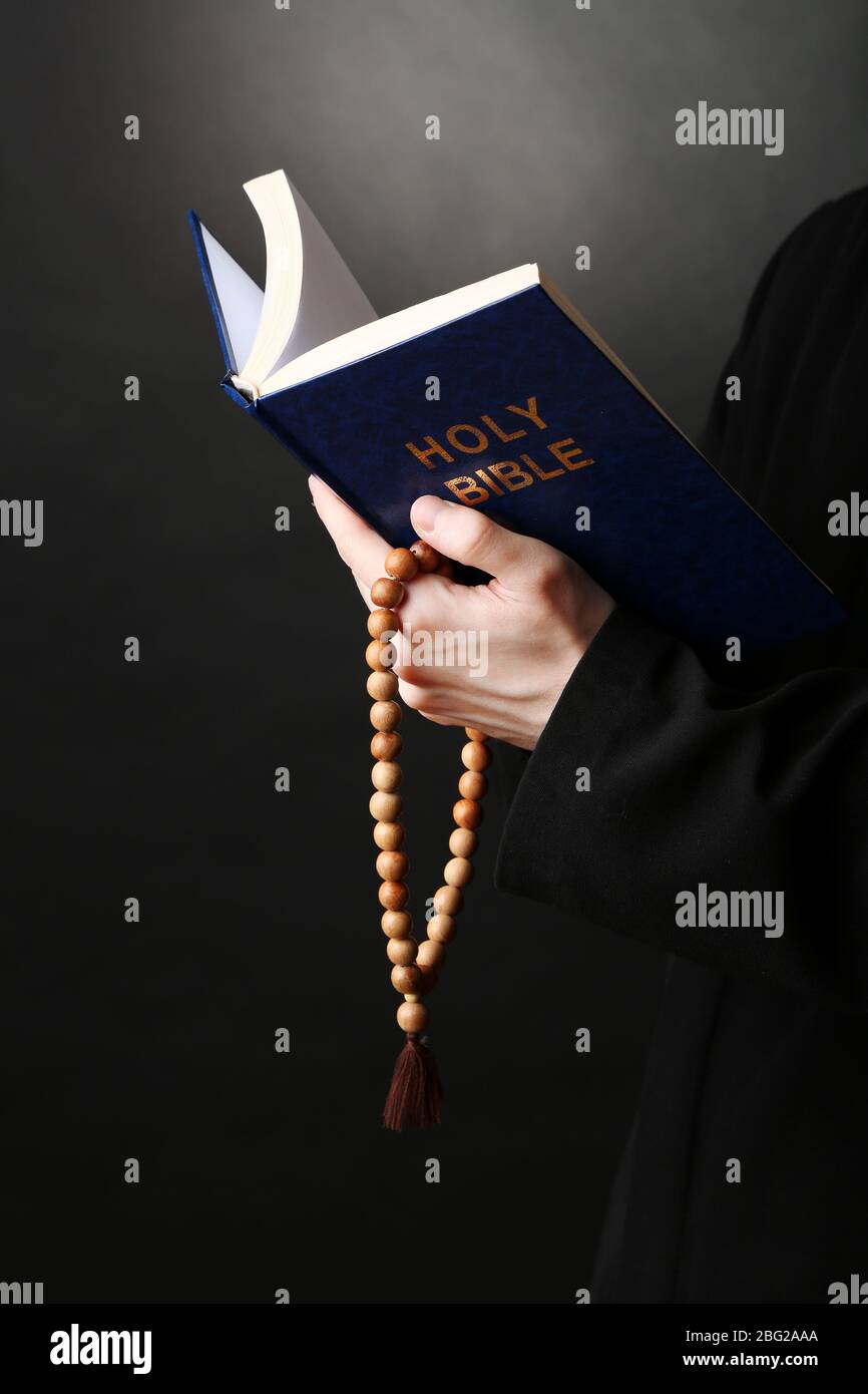 Priest reading from the holy bible, close up Stock Photo - Alamy
