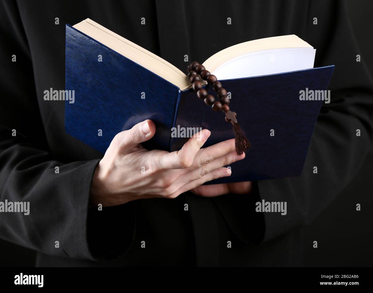 Priest reading from the holy bible, close up Stock Photo - Alamy