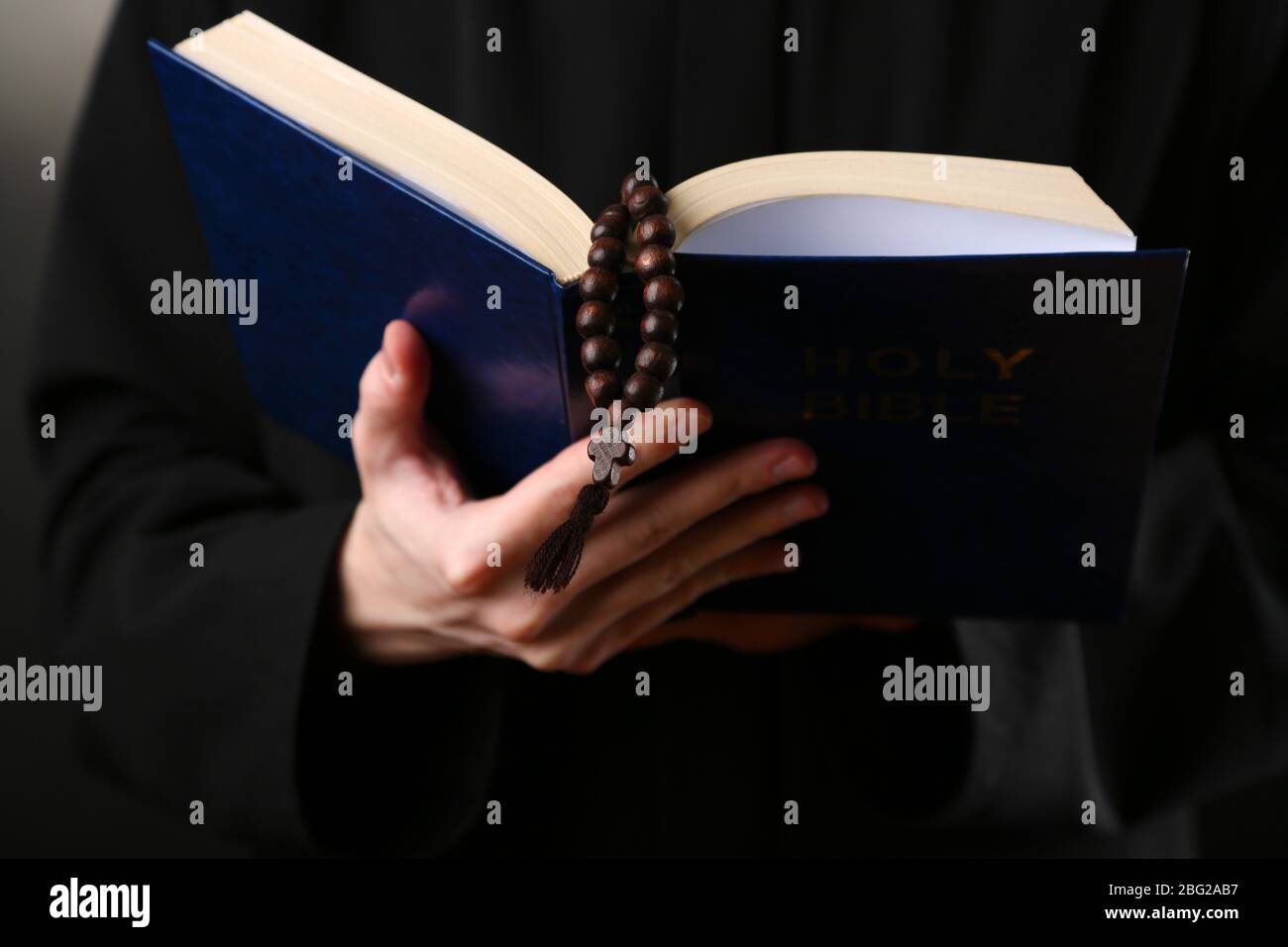 Priest reading from the holy bible, close up Stock Photo - Alamy
