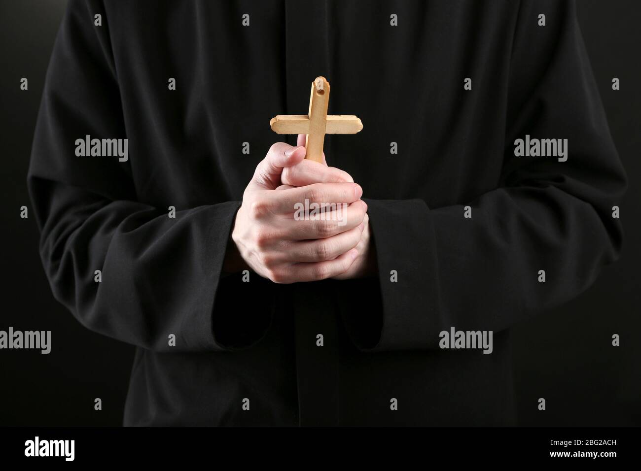 Priest holding cross hi-res stock photography and images - Alamy