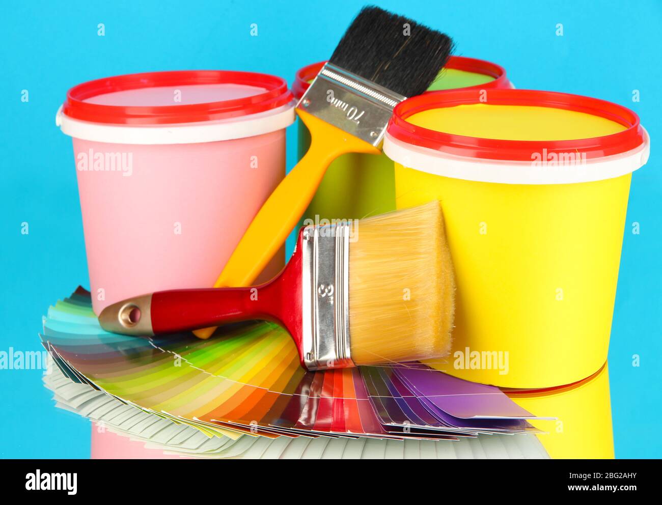 Set for painting: paint pots, brushes, palette of colors on blue ...