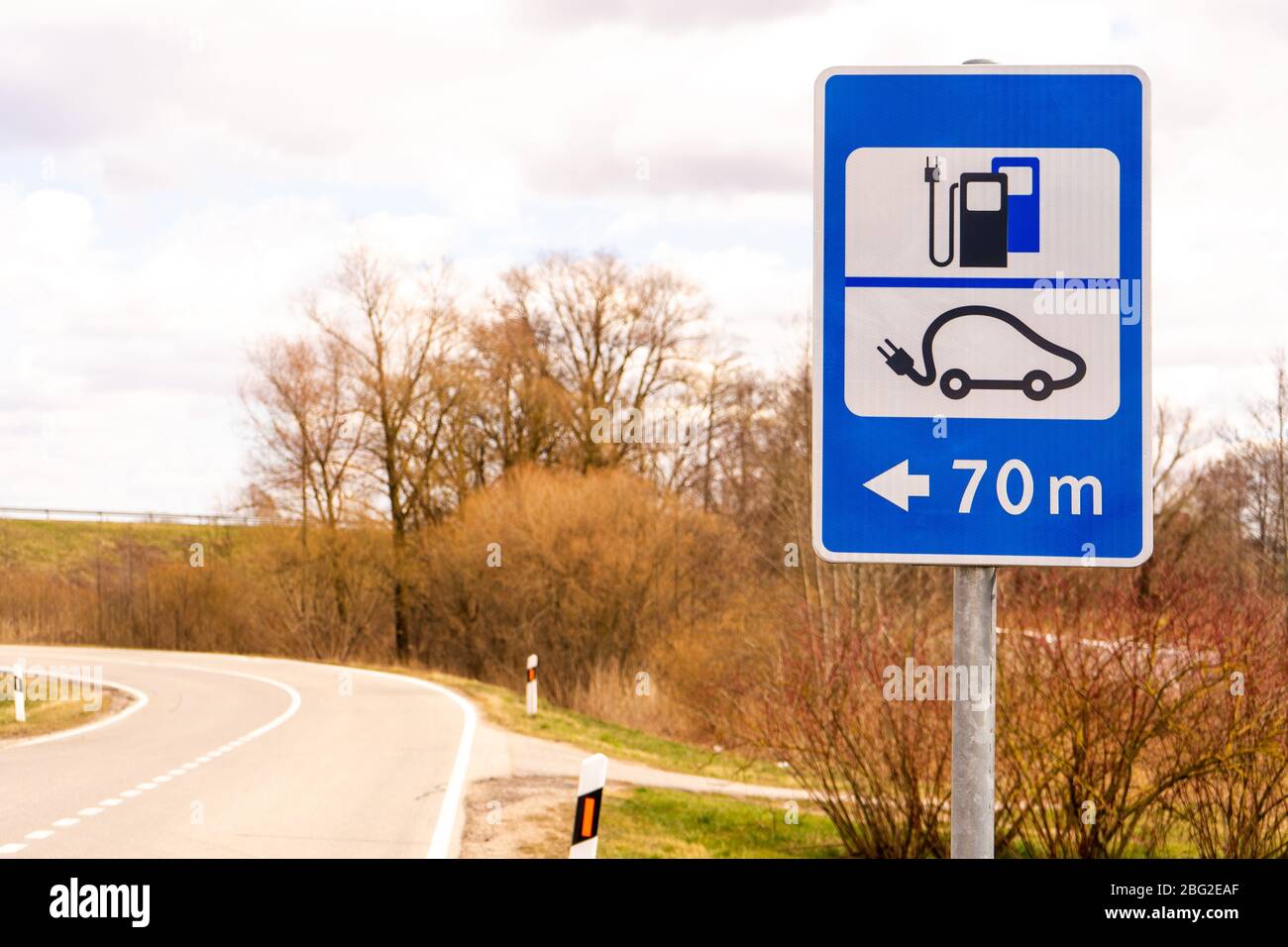 Electric car charging point sign in nature. EV parking and recharging ...