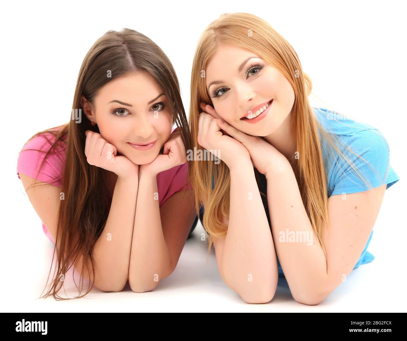 Two girl friends smiling isolated on white Stock Photo - Alamy