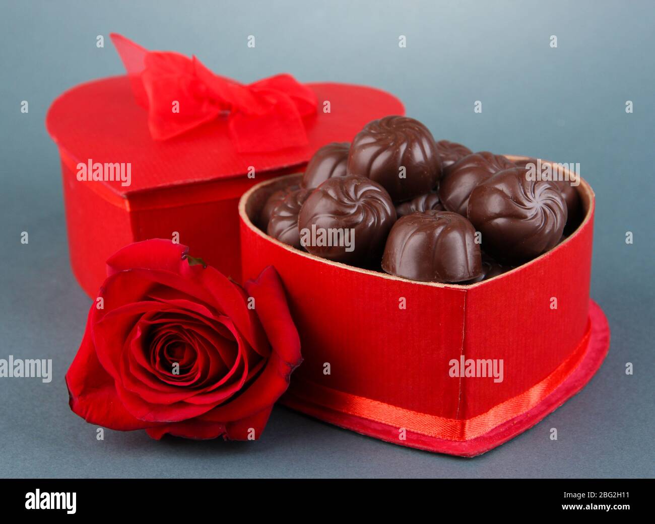 Chocolate candies in gift box, on grey background Stock Photo - Alamy