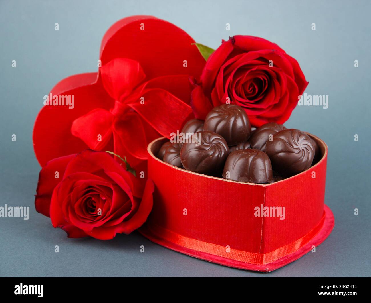 Chocolate candies in gift box, on grey background Stock Photo - Alamy