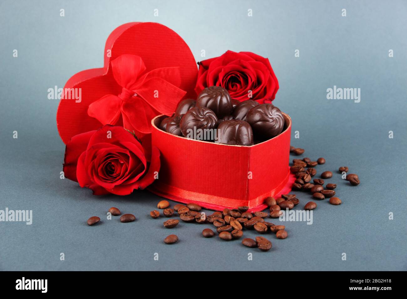 Chocolate candies in gift box, on grey background Stock Photo - Alamy