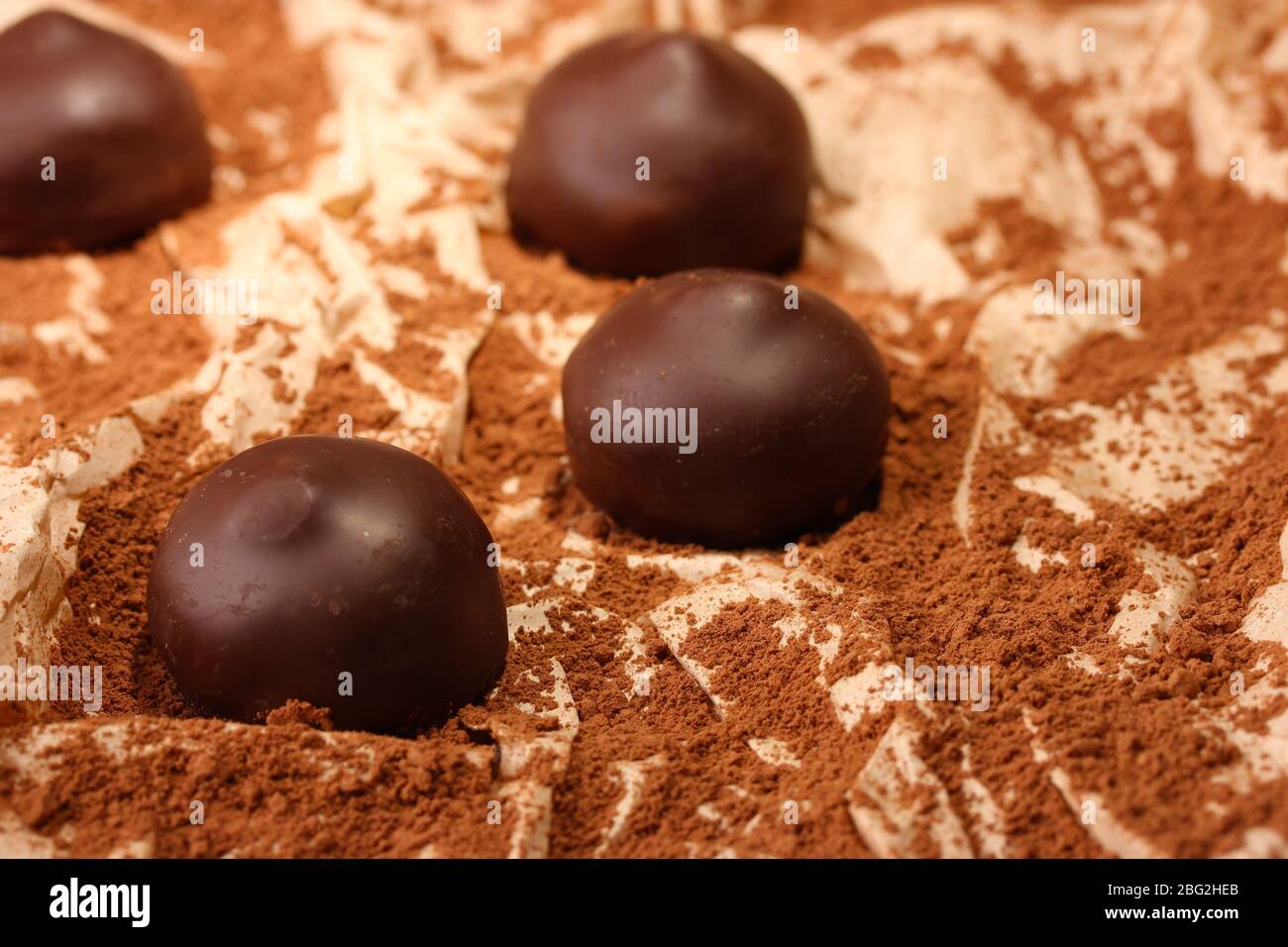 Chocolate candies with cocoa powder, close up Stock Photo - Alamy