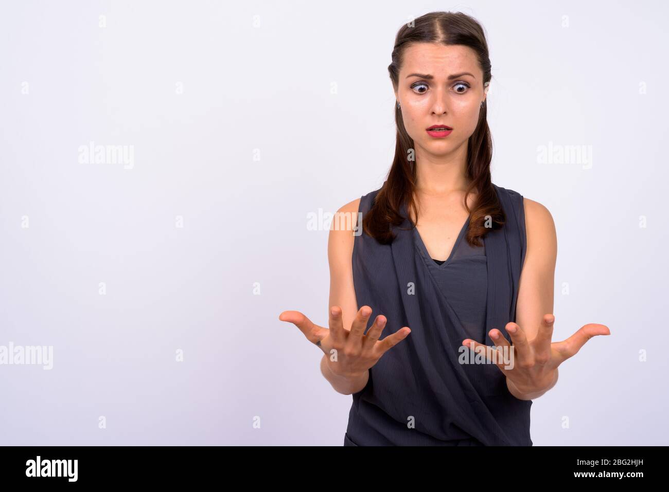 Portrait of shocked young woman looking at hands Stock Photo - Alamy