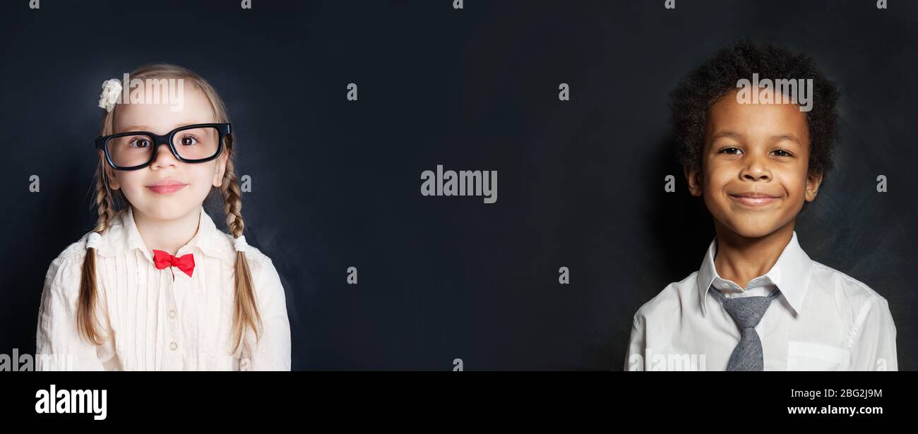 Smart kids students girl and boy on blackboard background Stock Photo ...