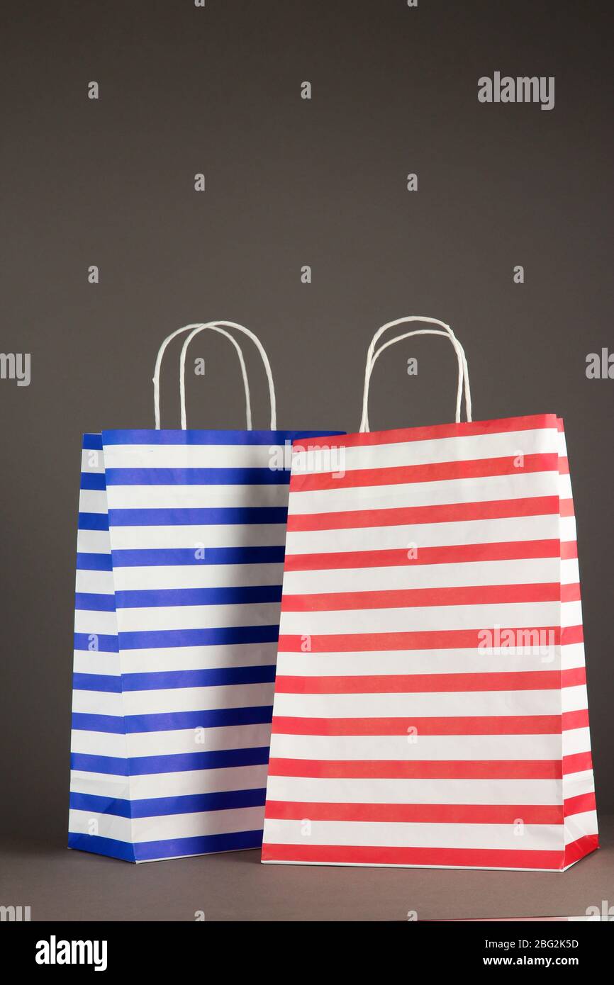 Striped bags on gray background Stock Photo - Alamy