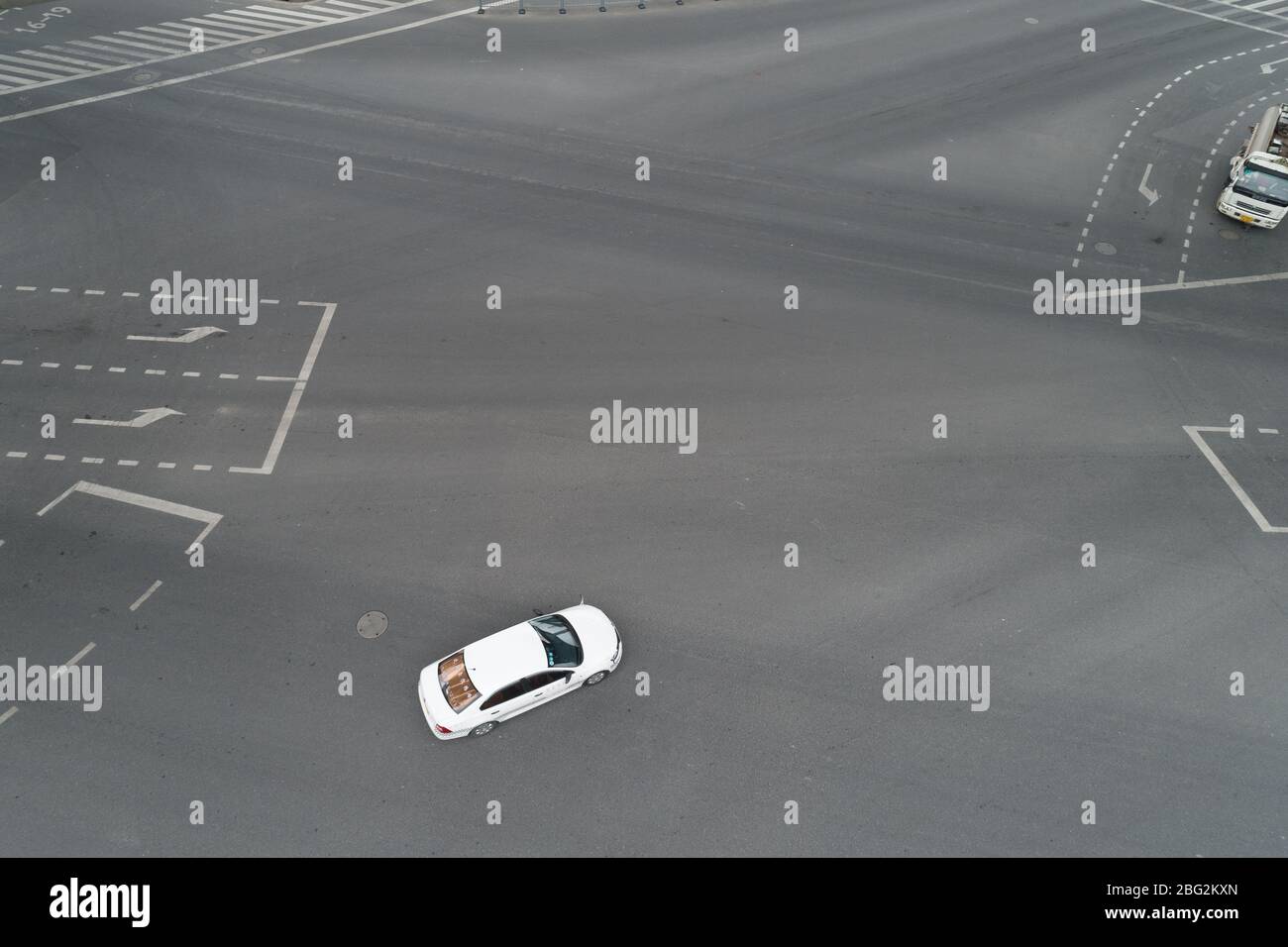 Aerial view of single car driving on intersection Stock Photo - Alamy
