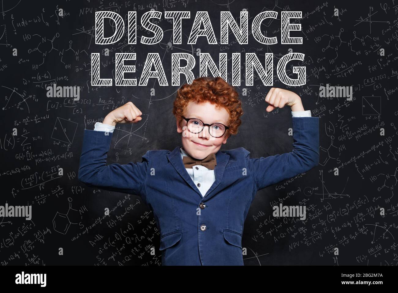 Strong child boy on blackboard background. Distance learning and happy ...