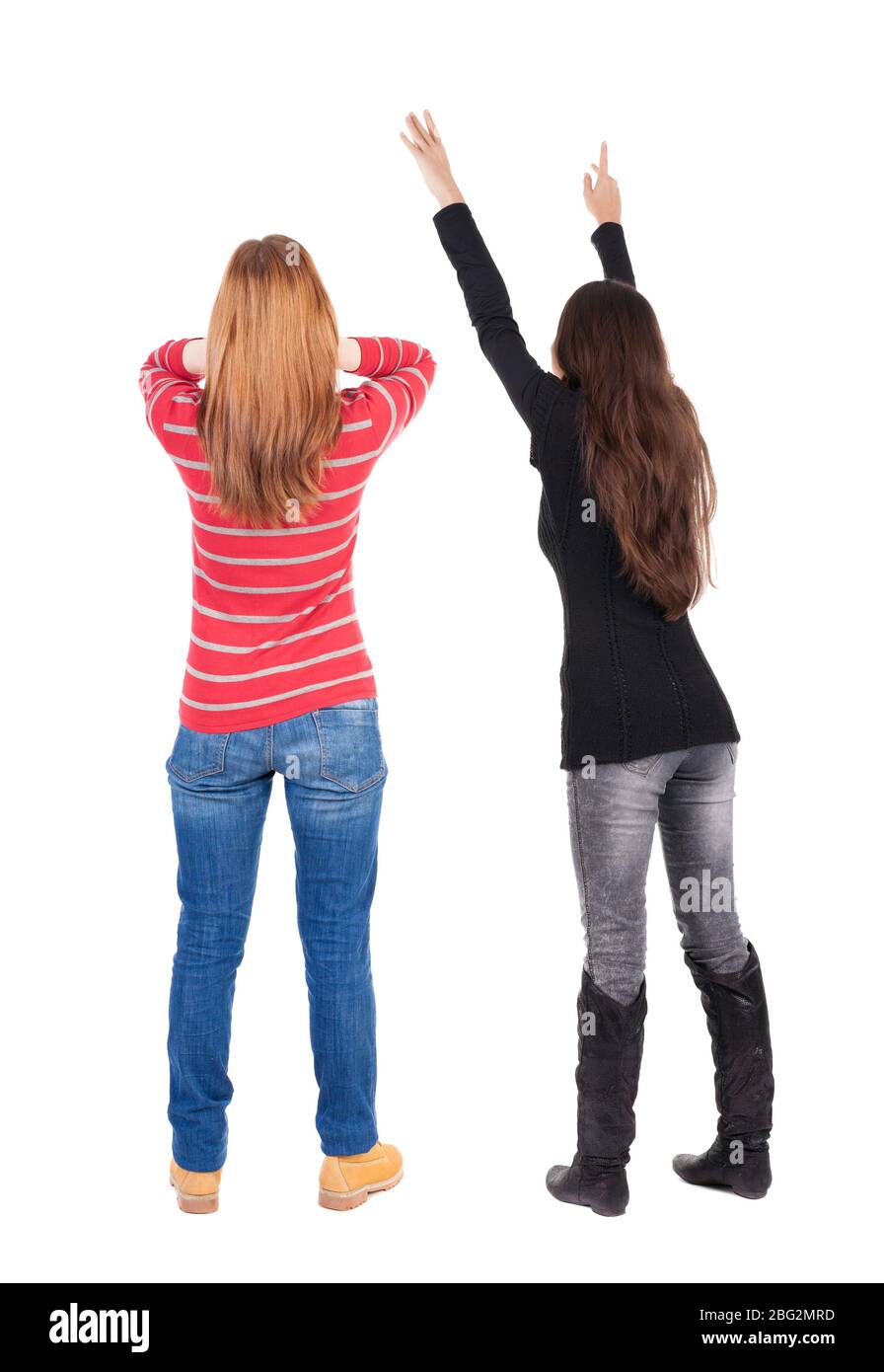 Back view of two pointing girl in sweater. Rear view people collection ...