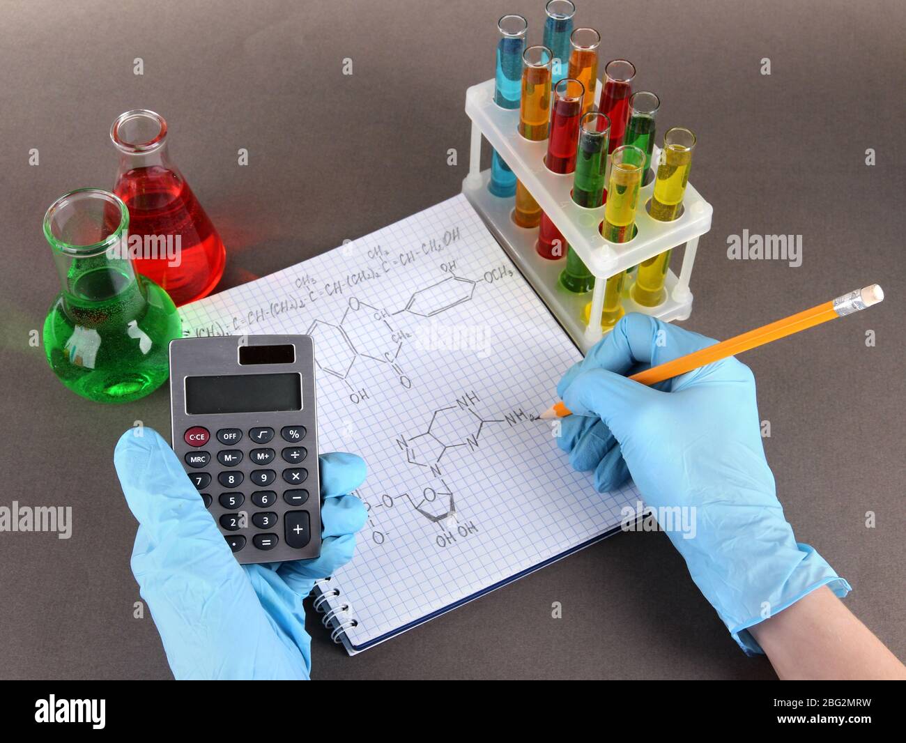 Hand scientist writing formulas Stock Photo - Alamy