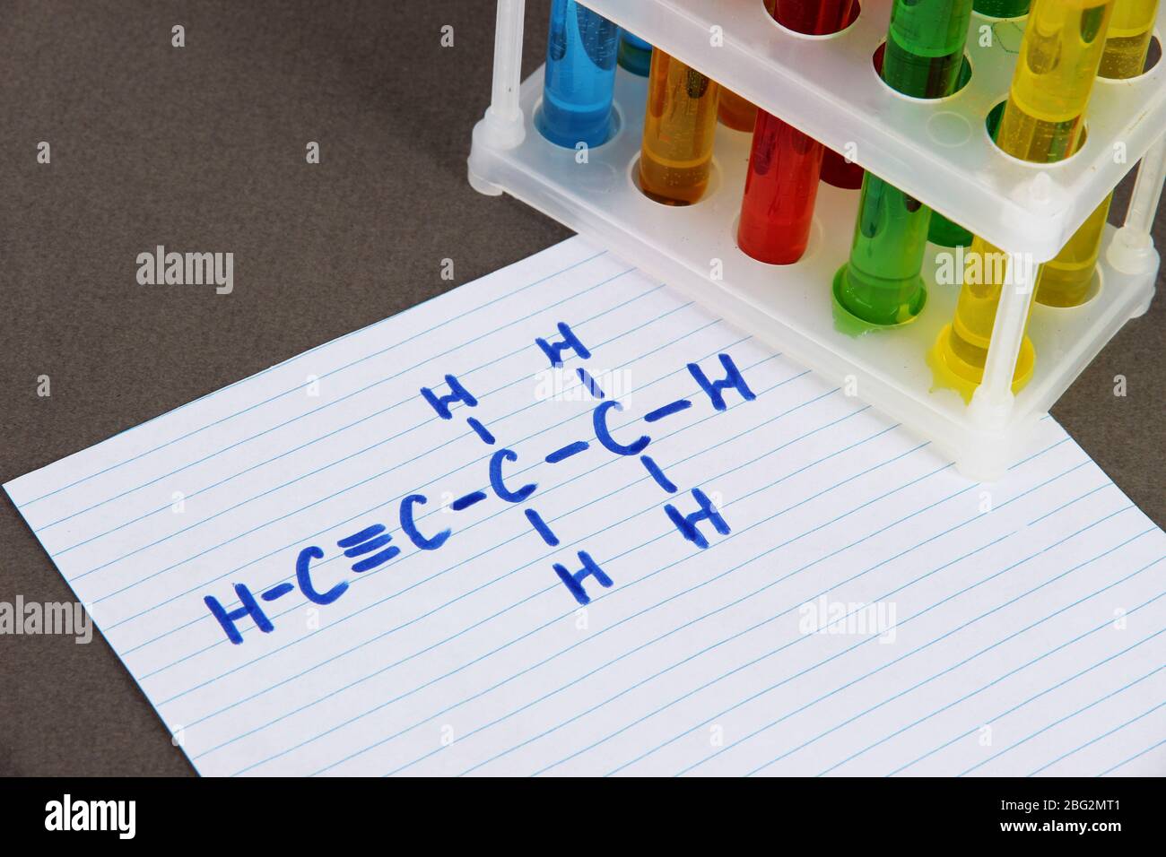 Test tubes with colorful liquids and formulas on grey background Stock ...