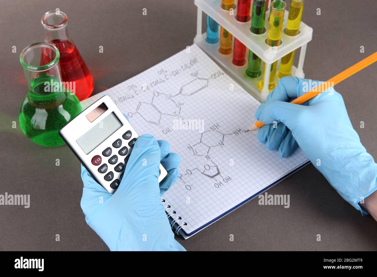 Hand scientist writing formulas Stock Photo - Alamy