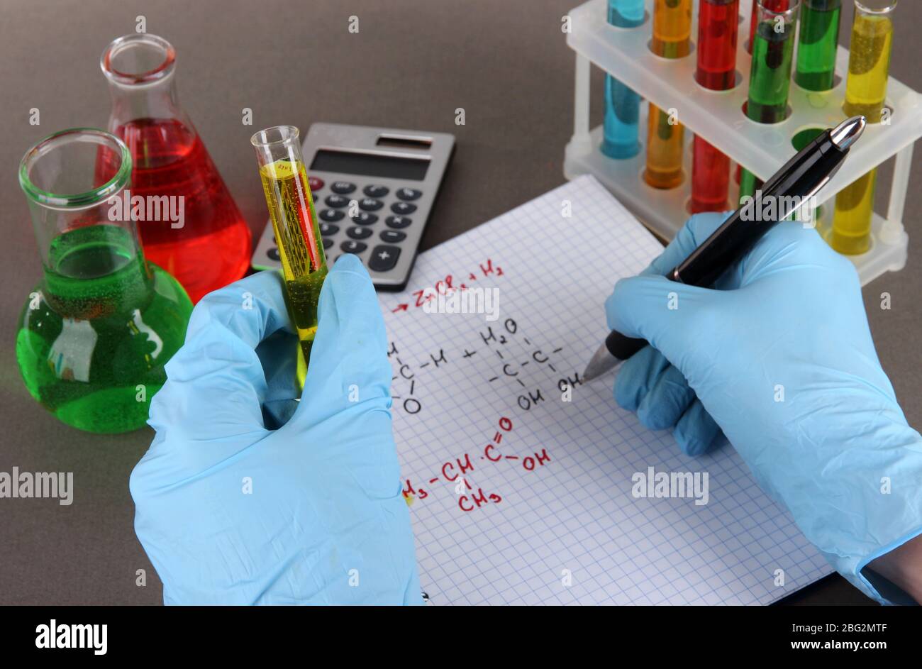 Hand scientist writing formulas Stock Photo - Alamy