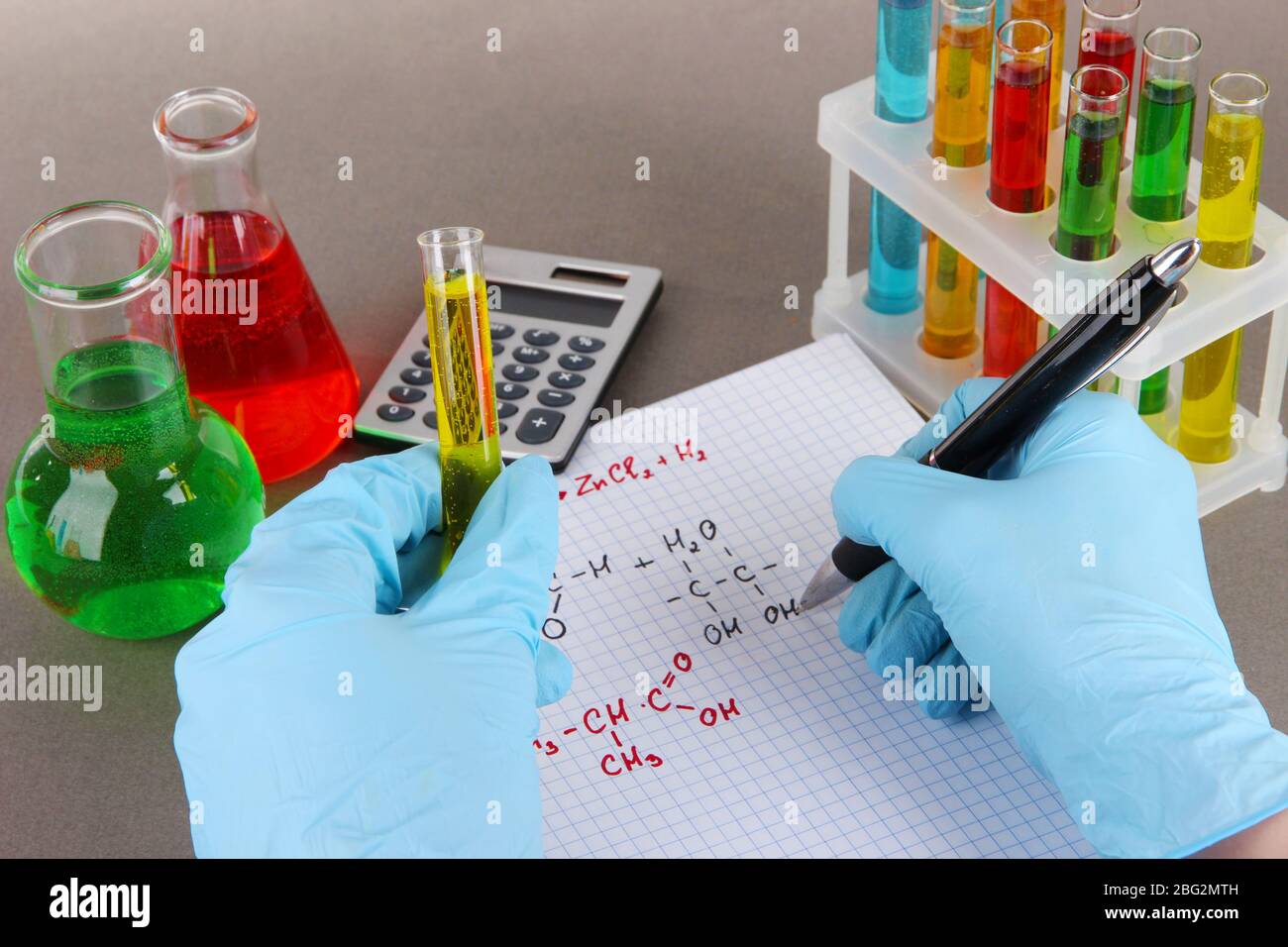 Hand scientist writing formulas Stock Photo - Alamy