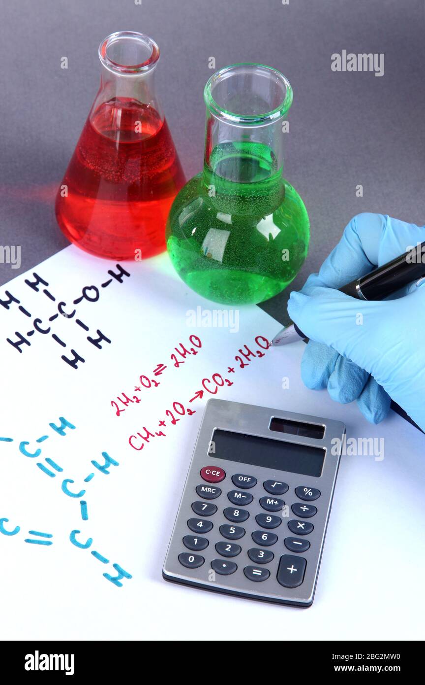 Hand scientist writing formulas Stock Photo - Alamy