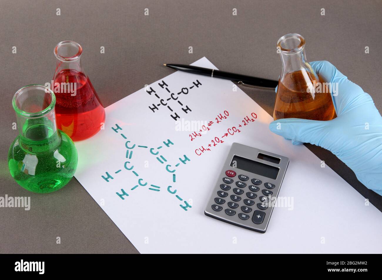 Test tubes with colorful liquids and formulas on grey background Stock ...