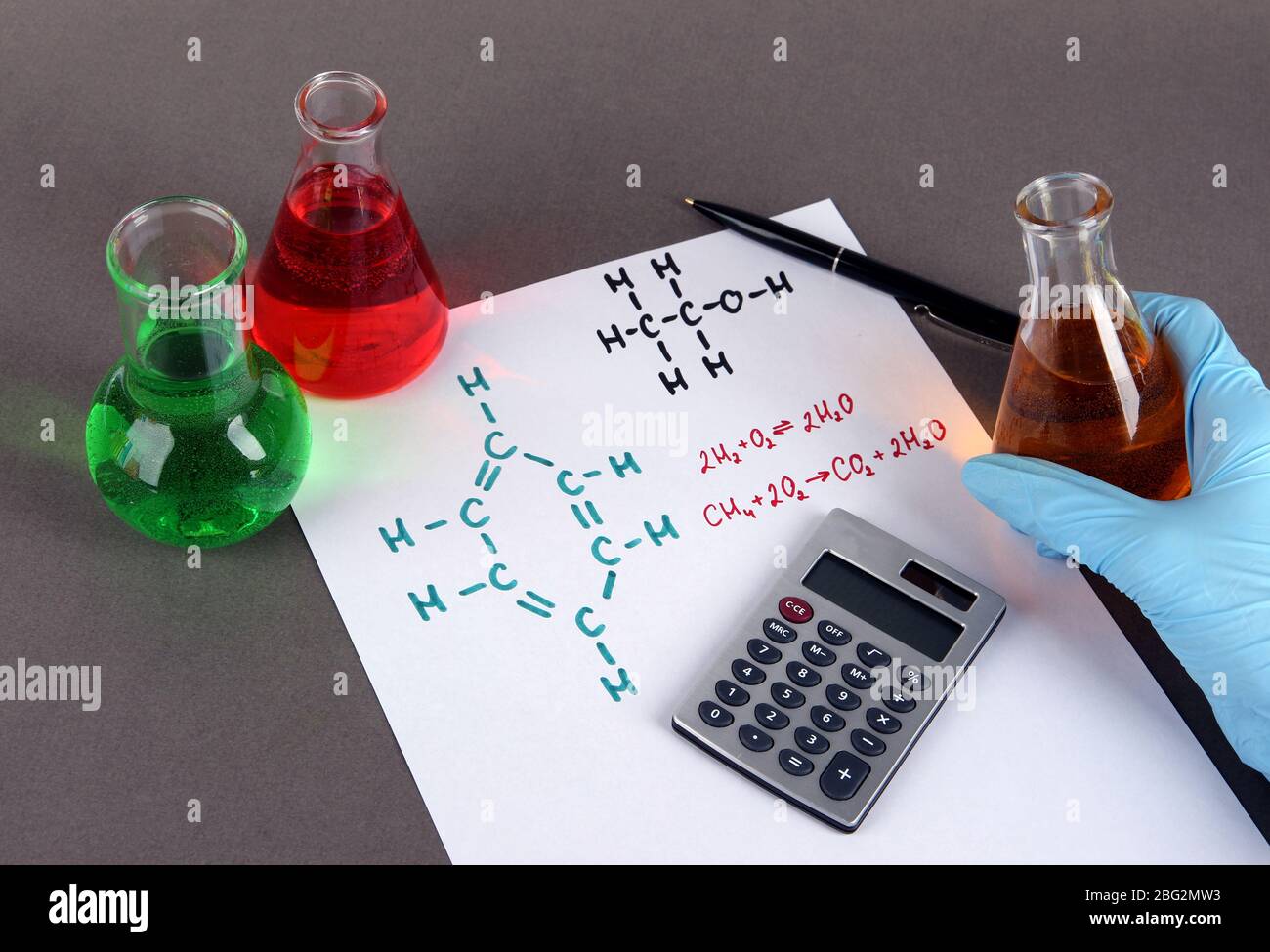 Test tubes with colorful liquids and formulas on grey background Stock ...