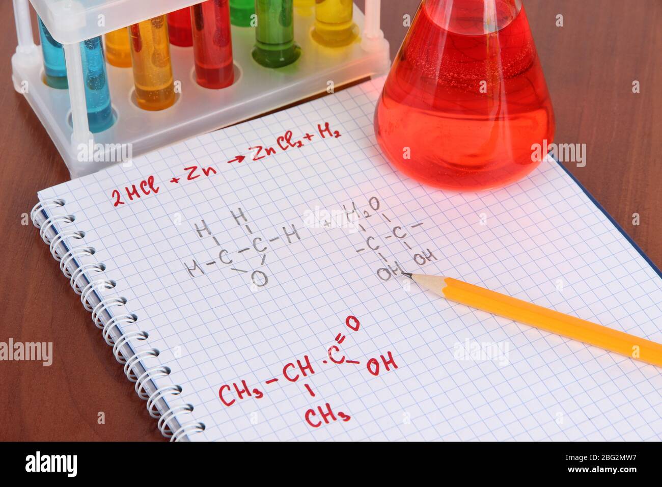 Test tubes with colorful liquids and formulas on table Stock Photo - Alamy