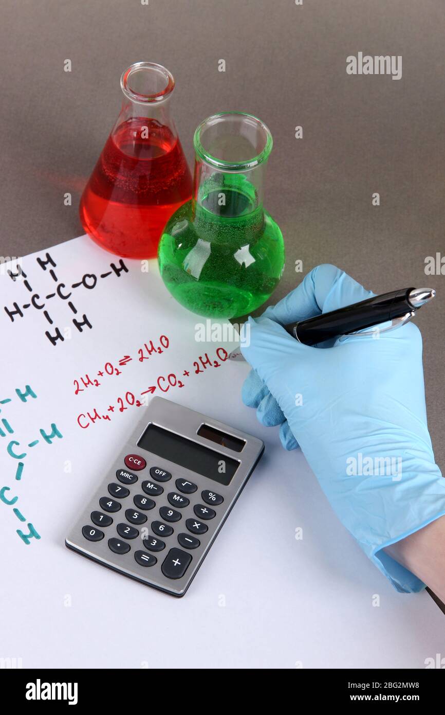 Hand scientist writing formulas Stock Photo - Alamy