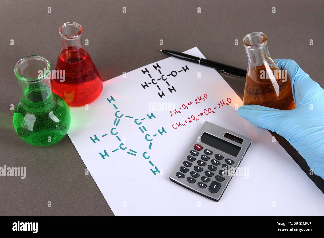 Test tubes with colorful liquids and formulas on grey background Stock ...