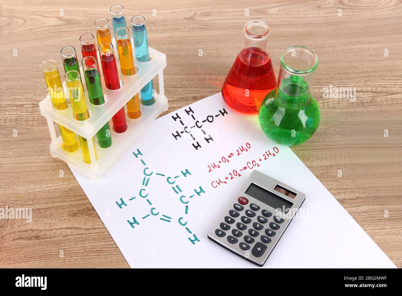 Test tubes with colorful liquids and formulas on table Stock Photo - Alamy