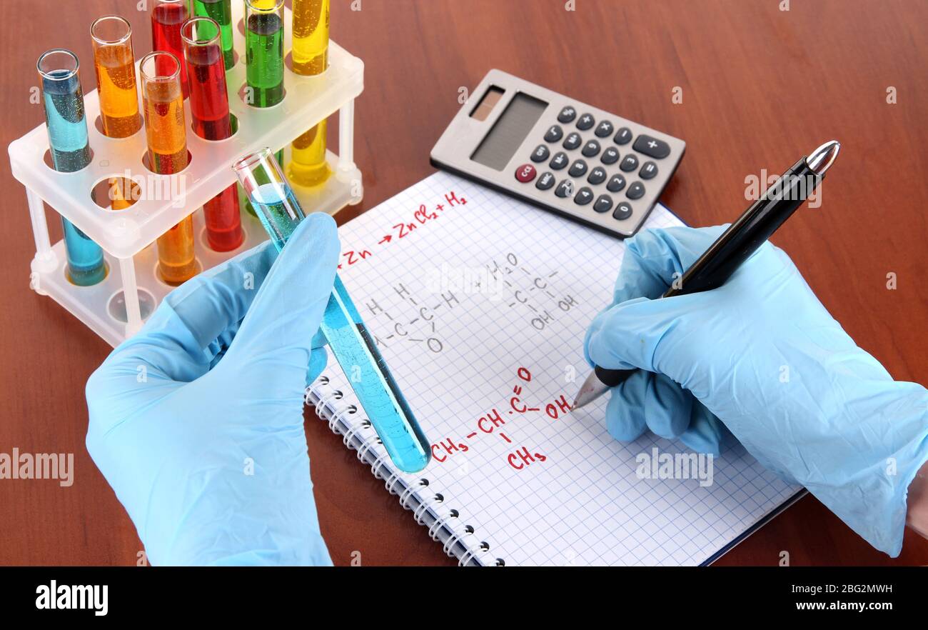 Hand scientist writing formulas Stock Photo - Alamy