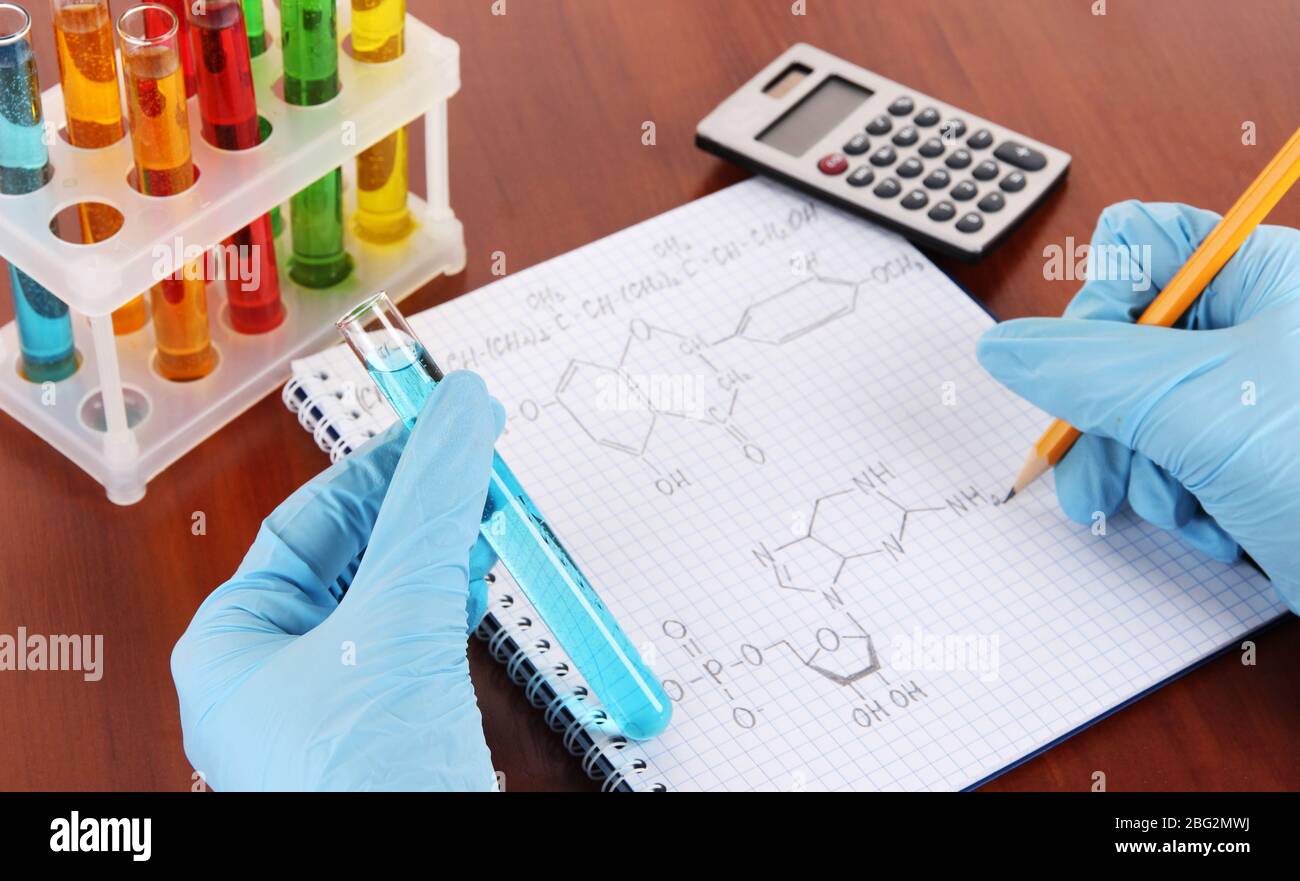 Hand scientist writing formulas Stock Photo - Alamy