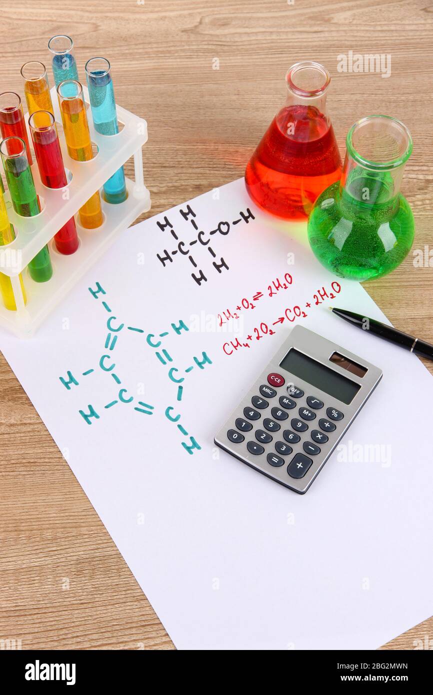 Test tubes with colorful liquids and formulas on table Stock Photo - Alamy