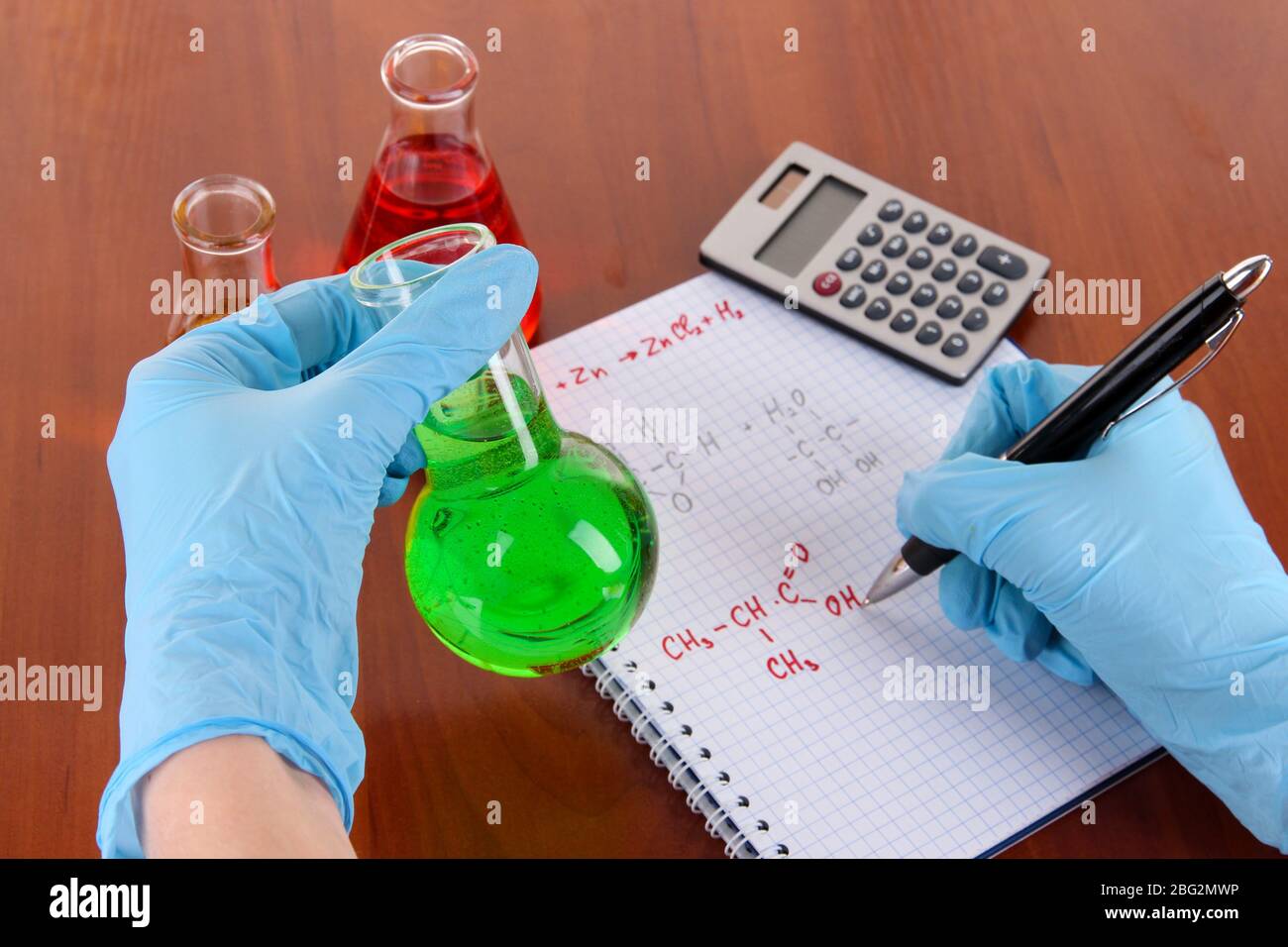 Hand scientist writing formulas Stock Photo - Alamy