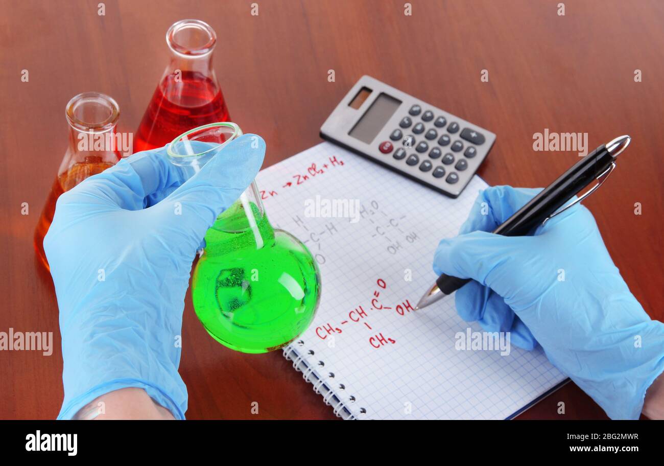 Hand scientist writing formulas Stock Photo - Alamy