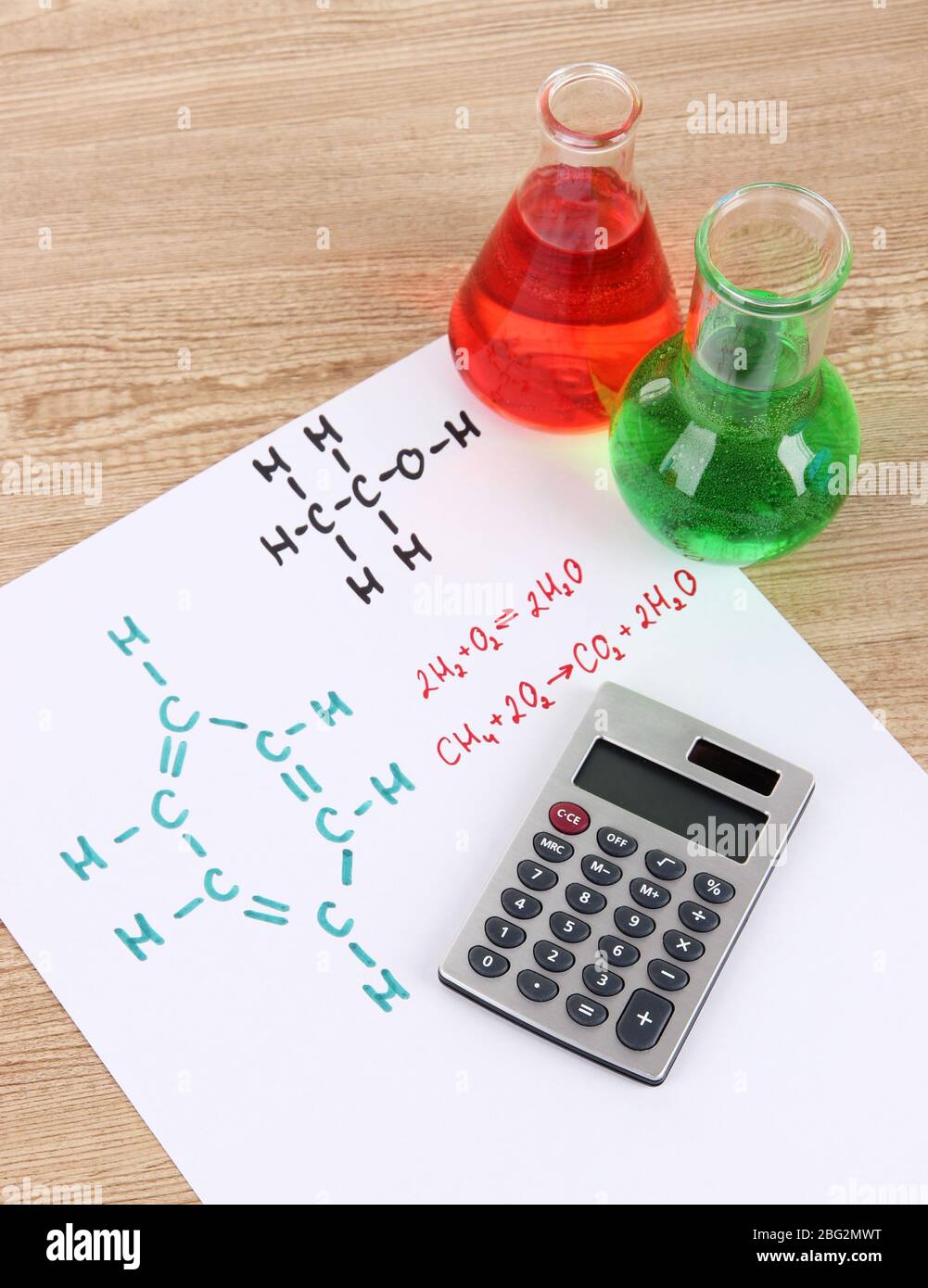 Test tubes with colorful liquids and formulas on table Stock Photo - Alamy