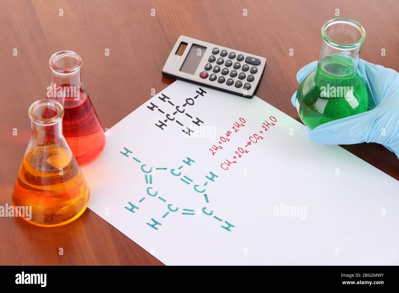 Test tubes with colorful liquids and formulas on table Stock Photo - Alamy
