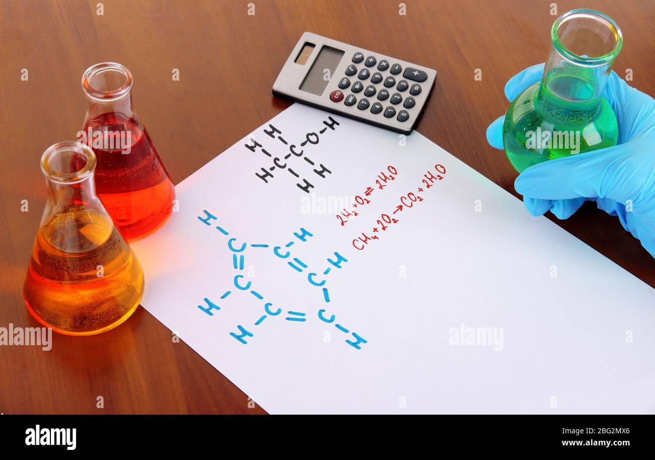 Test tubes with colorful liquids and formulas on table Stock Photo - Alamy