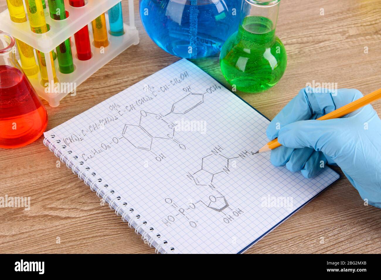 Hand scientist writing formulas Stock Photo - Alamy